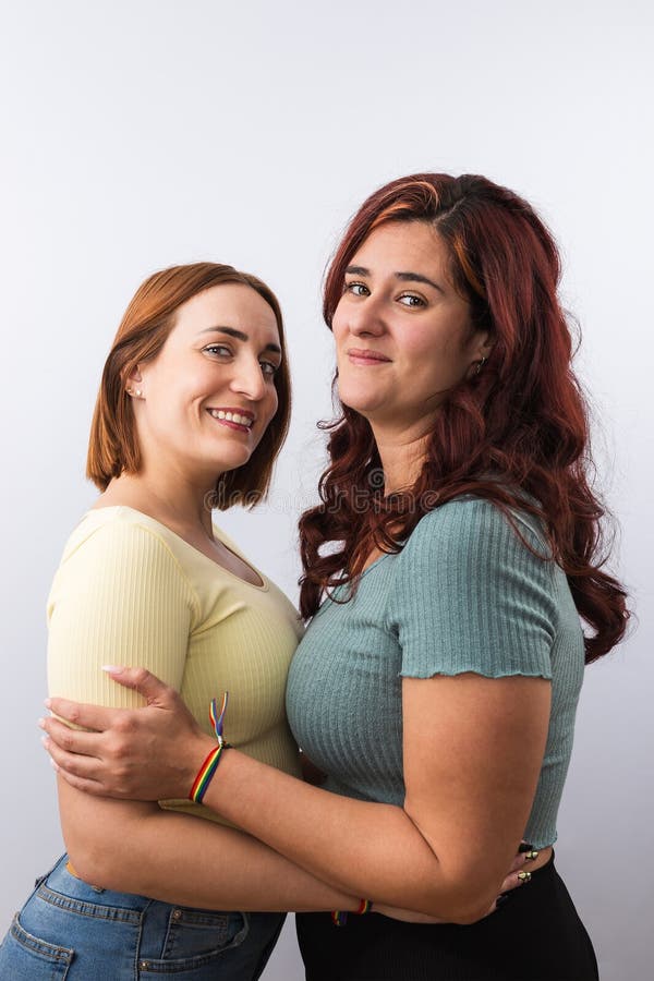 Portrait Of Young Redheaded Lesbian Couple Looking At Camera Hugging
