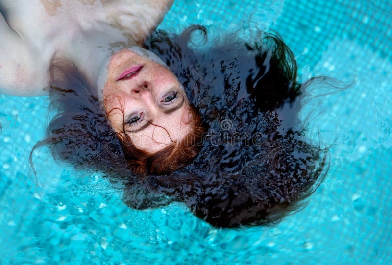 Portrait Of Young Redhead Woman Swimming In The Pool The Red Hair