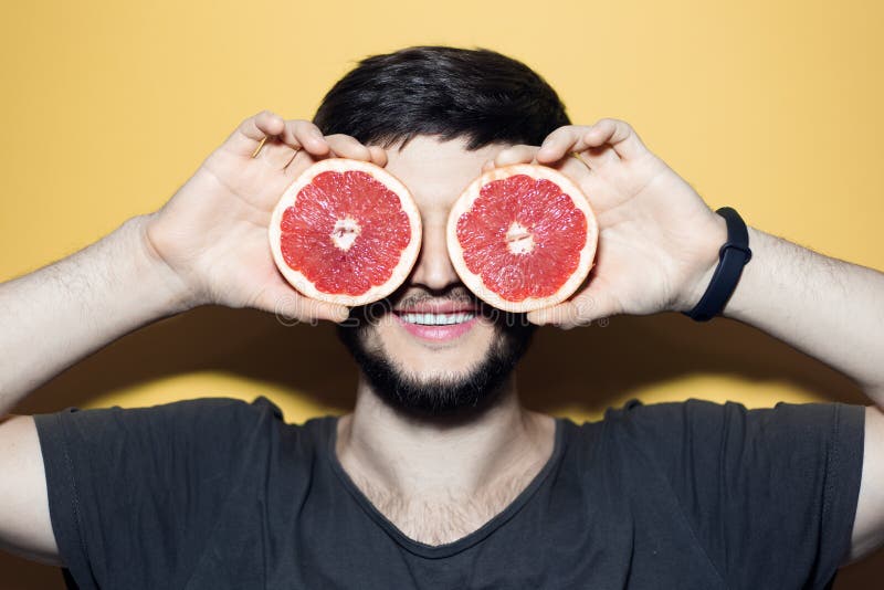 Portrait of Young Smiling Man with Grapefruit on Eyes, Isolated on ...