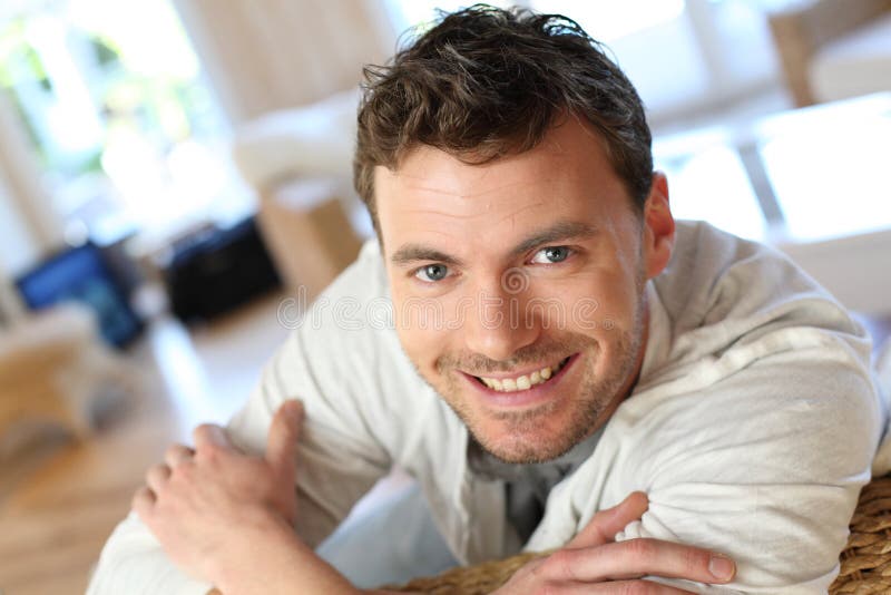 Portrait of Young Smiling Man Relaxing at Home Stock Image - Image of ...