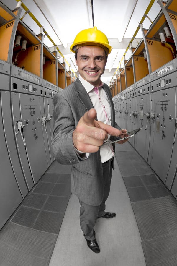 Portrait of Young Smiling Supervisor with Tablet PC Pointing at You in ...