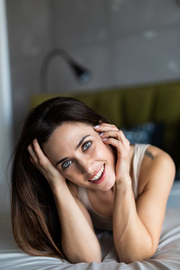 Portrait of Young Smiling Woman Lying on Bed Stock Photo - Image of ...