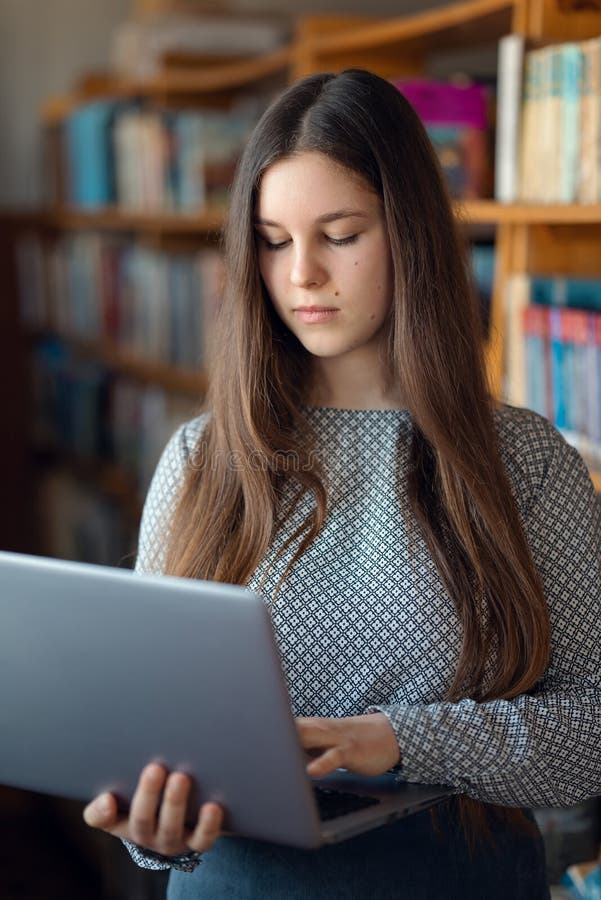 Portrait of a Young Student with Laptop in Library Stock Photo - Image ...