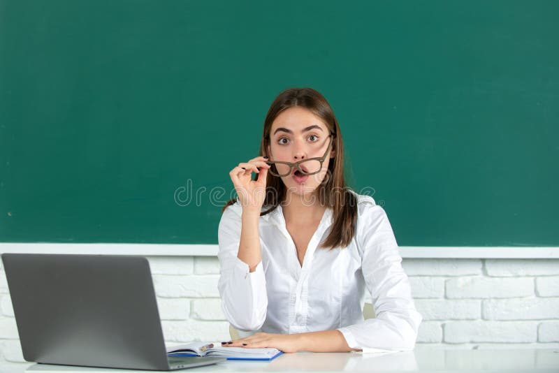 Portrait of a Young Surprised Female Student Studying in School ...
