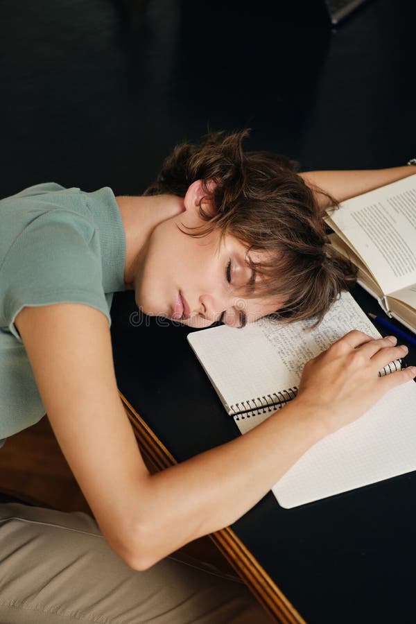Portrait of Young Tired Female Student Sleeping on Desk with Book and ...