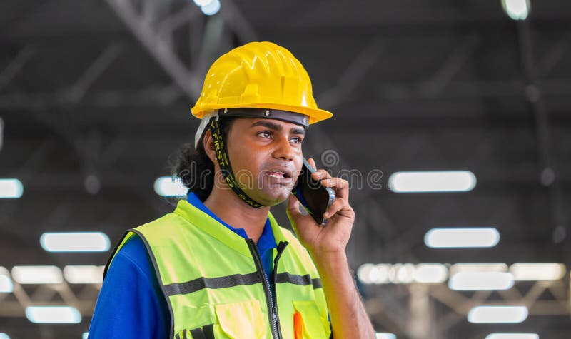 Portrait of Young Warehouse Worker Standing in Warehouse Using Mobile ...