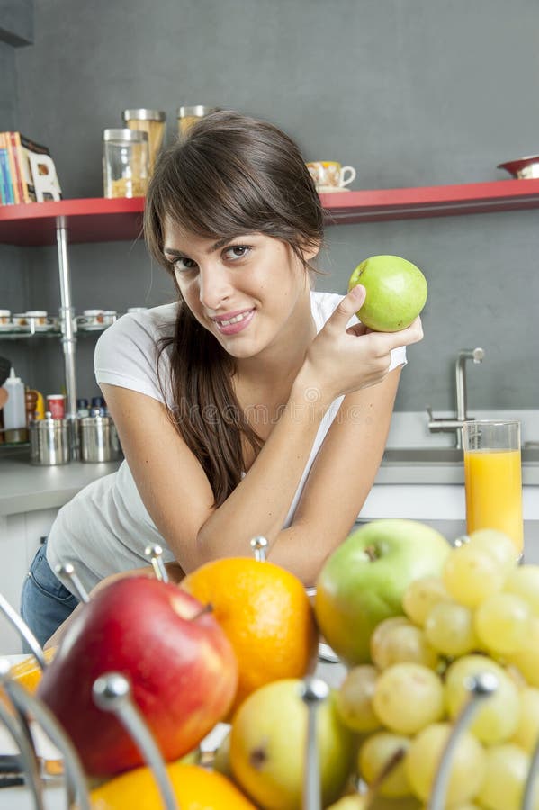 Portrait of Young Woman with Apple in Kitchen Stock Photo - Image of ...