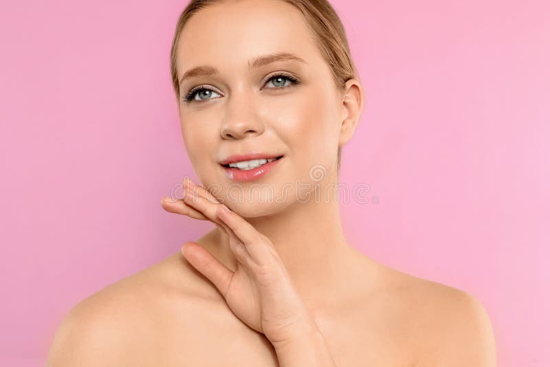Portrait Of Young Woman With Beautiful Face On Pink Background Stock