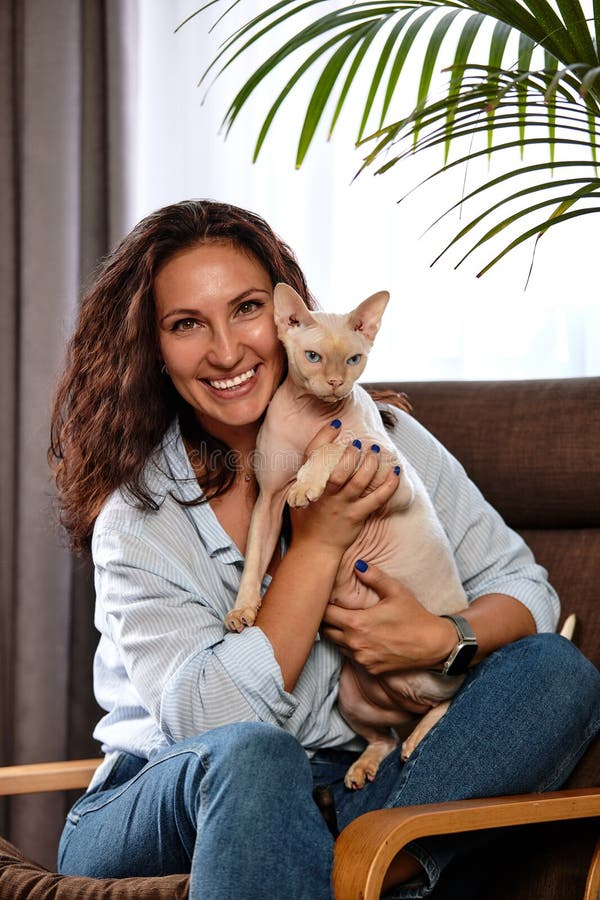 Portrait Of Young Woman Holding Cute Cat With Blue Eyes Female Hugging
