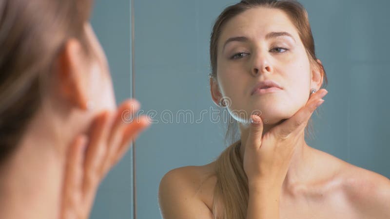 Young Woman Checking Her Face and Looking for Skin Problems and Acne ...