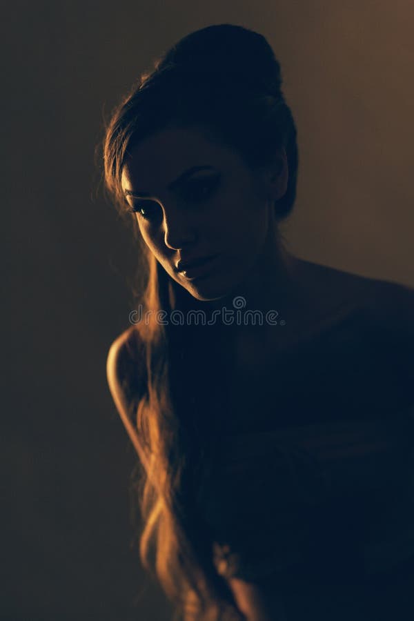 Portrait of Young Woman in Low Light Looking Down Stock Photo - Image ...