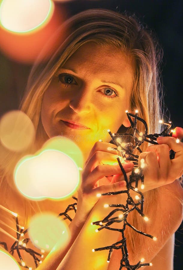 Young Woman Lying on Bed with Small Lights Around Body Stock Image ...