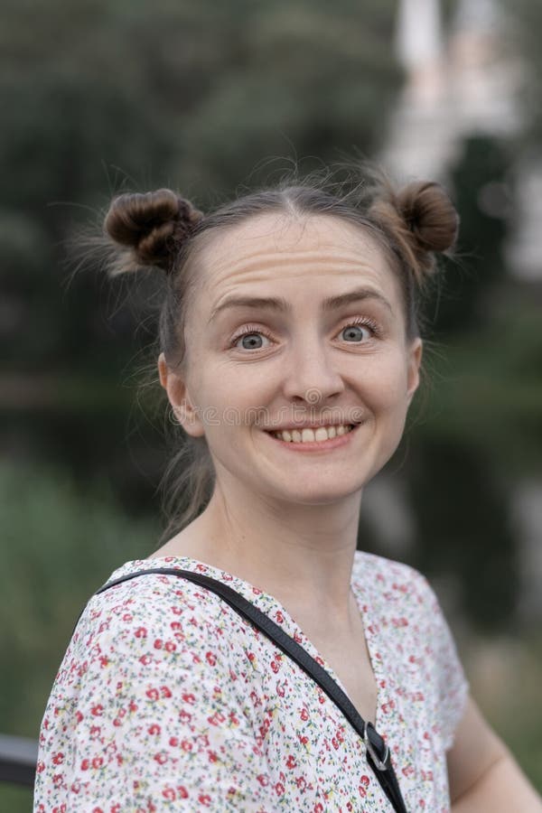 Portrait of Young Woman with Two Ponytails Smiling Happily and Raising ... Portrait of Young Woman with Two Ponytails Smiling Happily and Raising ...