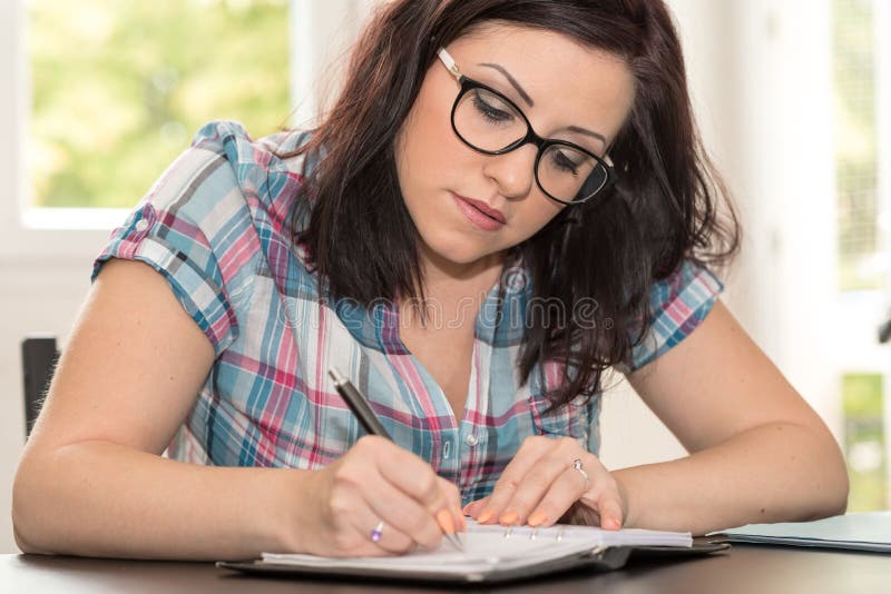 Portrait of a Young Woman Writing on a Notebook Stock Photo - Image of ...