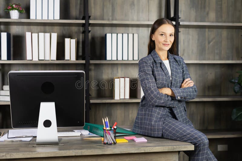 Portrati of Young Woman Cross Arm, Sit on Table, and Looks at Camera ... Portrati of Young Woman Cross Arm, Sit on Table, and Looks at Camera ...