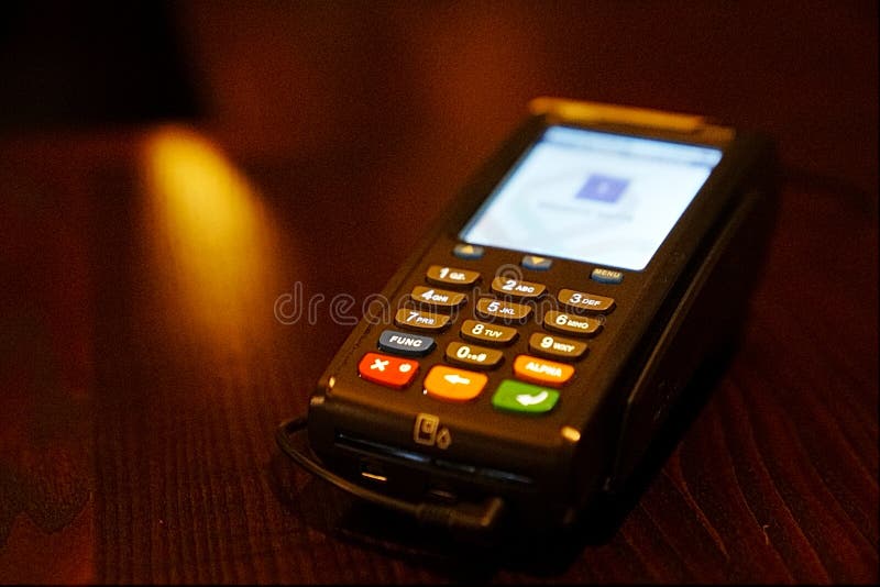 A POS Terminal on a Table in a Dark Room. Stock Image - Image of money ...