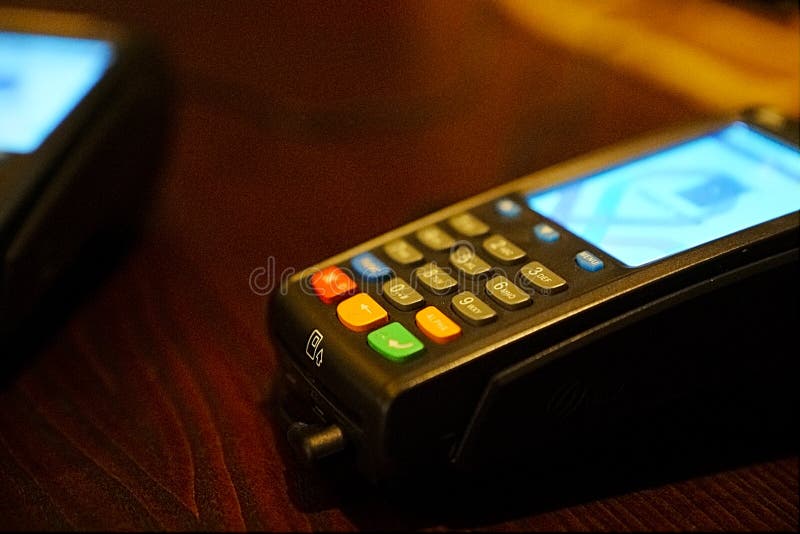 A POS Terminal on a Table in a Dark Room. Stock Image - Image of ...