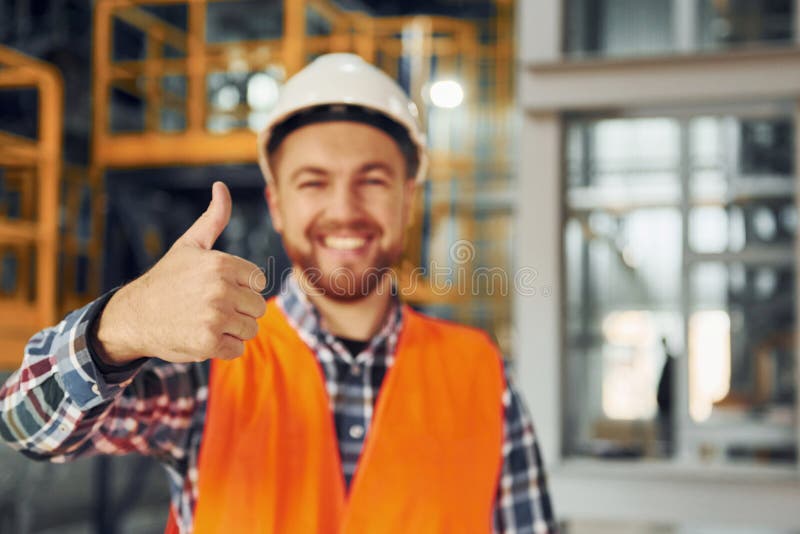 Posing for Camera. Construction Worker in Uniform is in the Factory ...
