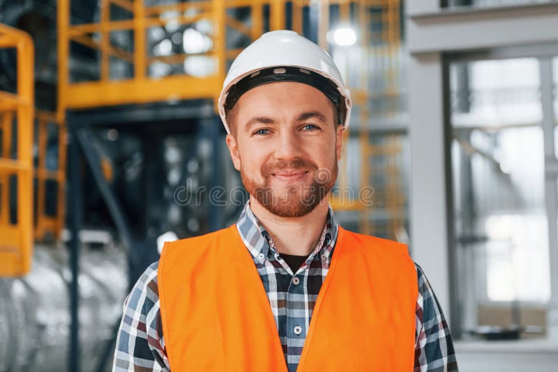 Posing for Camera. Construction Worker in Uniform is in the Factory ...