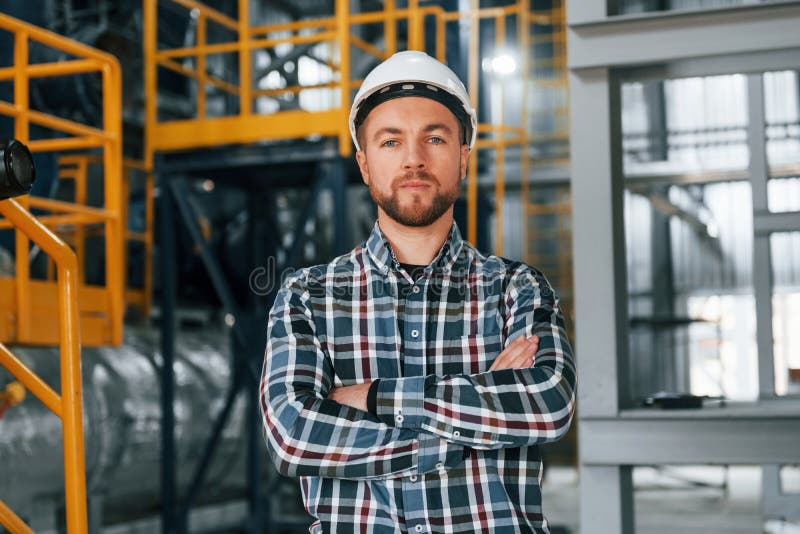 Posing for Camera. Construction Worker in Uniform is in the Factory ...