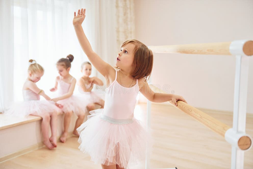 Posing for a Camera. Little Ballerinas Preparing for Performance Stock ...