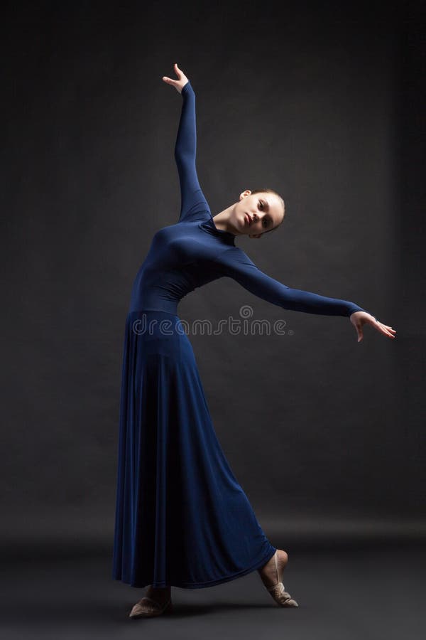 Posing Dancer in Blue Dress Over Dark Background Stock Image - Image of ...