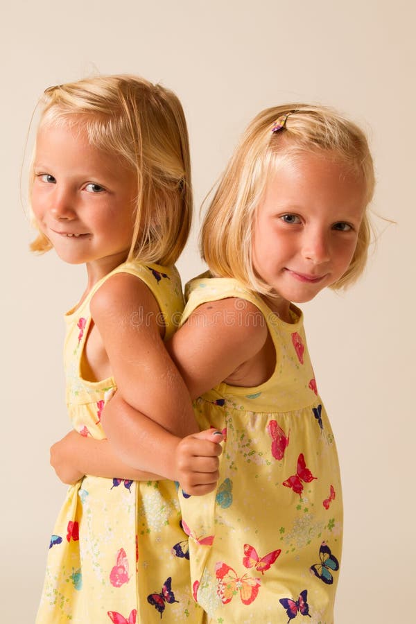 Posing twins stock image. Image of back, blond, happy - 26315191