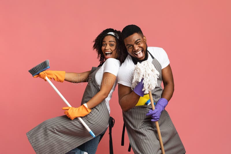 Positive Black Couple Enjoying Cleaning Together, Having Fun with Mop ... Positive Black Couple Enjoying Cleaning Together, Having Fun with Mop ...
