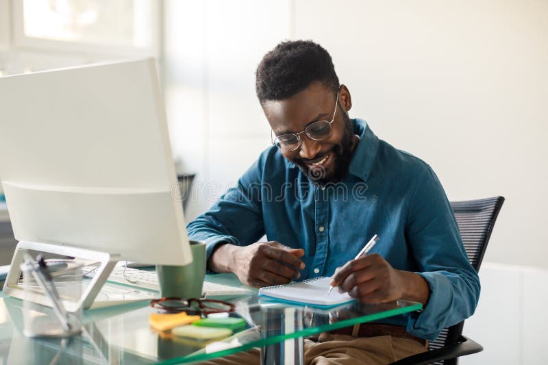 Positive Black Executive Ceo Manager Writing Notes in Notebook, Sitting ...