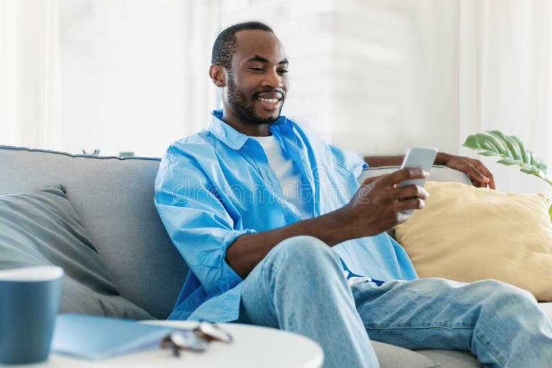 Positive Black Man Using Smartphone, Scrolling News Feed in Social ... Positive Black Man Using Smartphone, Scrolling News Feed in Social ...