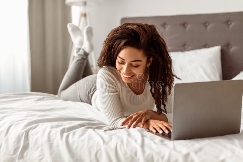 Positive Black Woman Lying in Bed Reading Text Message Stock Image - Image of lady, cellphone ...
