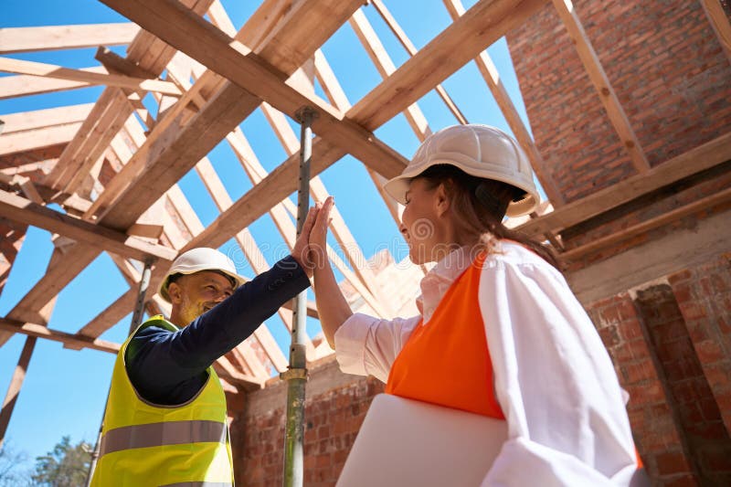 Positive Building Engineers Team Giving High Five To Each Other Stock ...