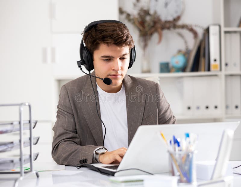 Positive Businessman with Headphones and Microphone Having Video Call ... Positive Businessman with Headphones and Microphone Having Video Call ...