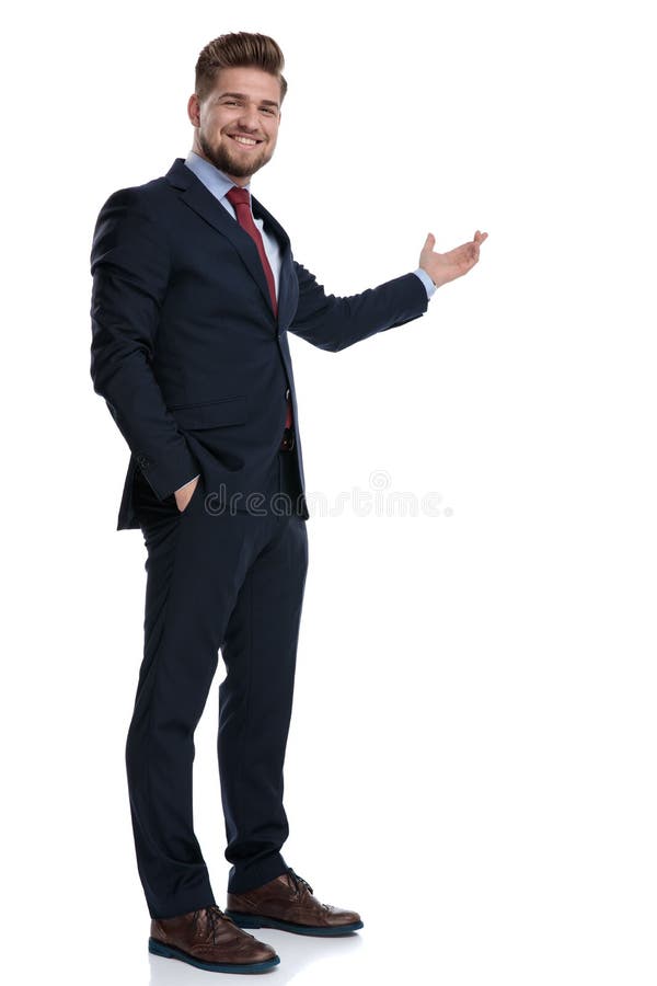 Positive Businessman Presenting And Holding His Hand In His Pocket ... Positive Businessman Presenting And Holding His Hand In His Pocket ...