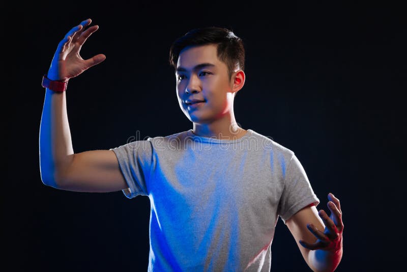 Positive Cheerful Man Holding a Virtual Object Stock Photo - Image of ...