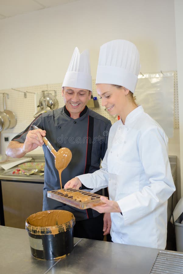 Positive Chef with Assistant Cooking at Kitchen in Restaurant Stock ...