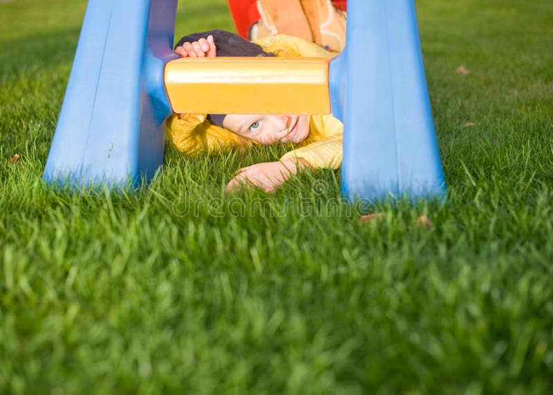 Positive Child Lay on Grass Near Slide Stock Image - Image of cute ...