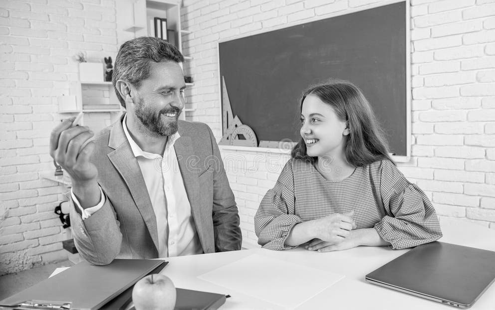 Positive Child Study in Classroom with Tutor Stock Image - Image of ...