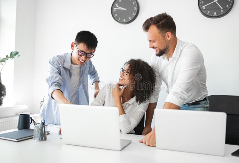 Positive Colleagues Working with Laptop in Office Stock Photo - Image ...