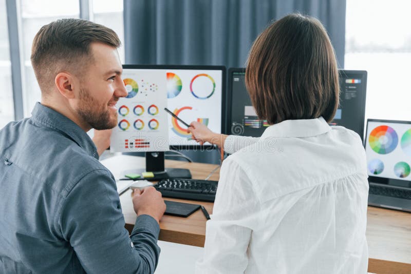 Positive Communication. Two Designers Working Together in the Office ...