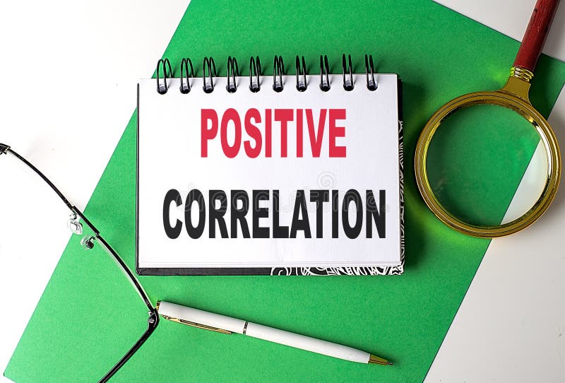 POSITIVE CORRELATION Text on Notebook on Green Paper Stock Photo ...
