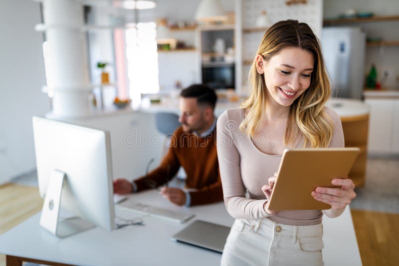 Positive Couple Having Fun while Working Together Remotely at Home ...