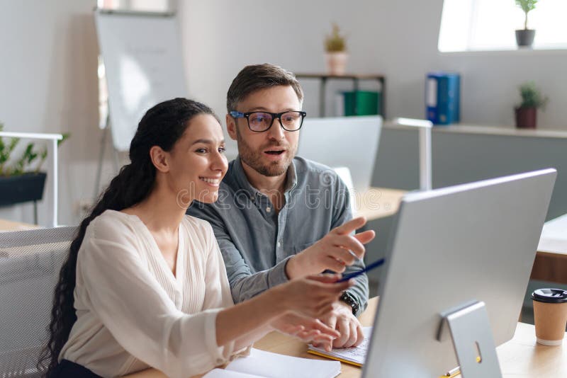 Positive Coworkers Pointing at Computer Screen, Working on Business ...