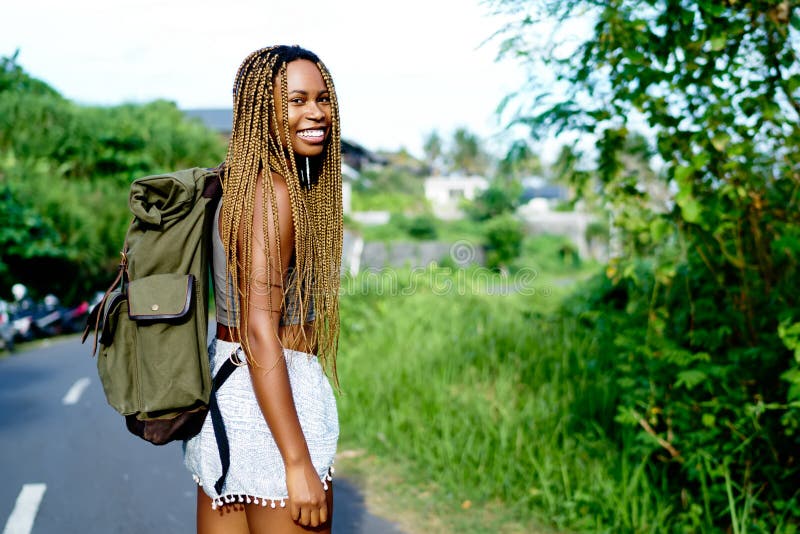 Positive Dark Skinned Traveller with Backpack Standing on Road Enjoying ...