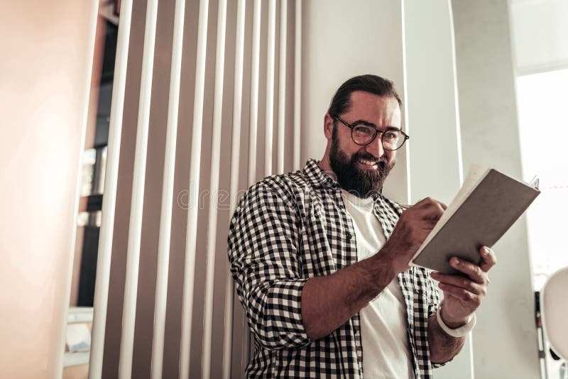 Positive Delighted Man Writing Down His Ideas Stock Photo - Image of ...