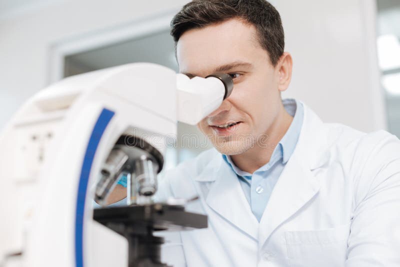 Positive Delighted Scientist Looking into Microscope Stock Photo ...