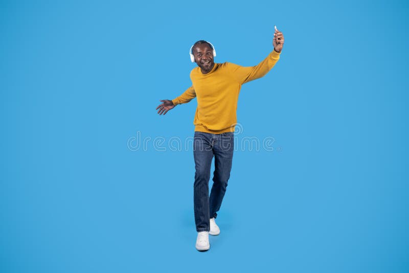 Positive Energetic Black Man With Headphones Listening To Music Stock