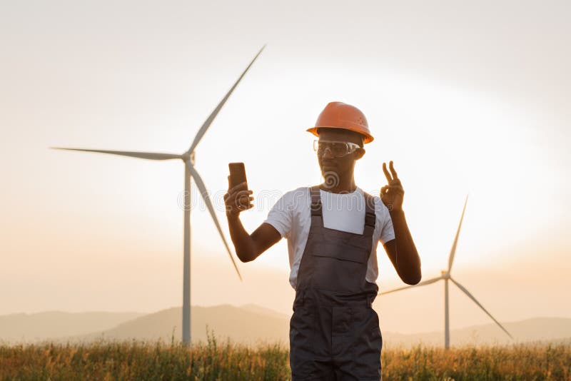 Engineer Having Video Call on Mobile among Windmill Farm Stock Image ...