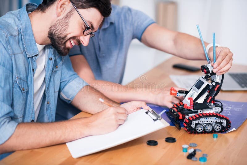 Positive Engineer Working with His Colleague Stock Photo - Image of ...
