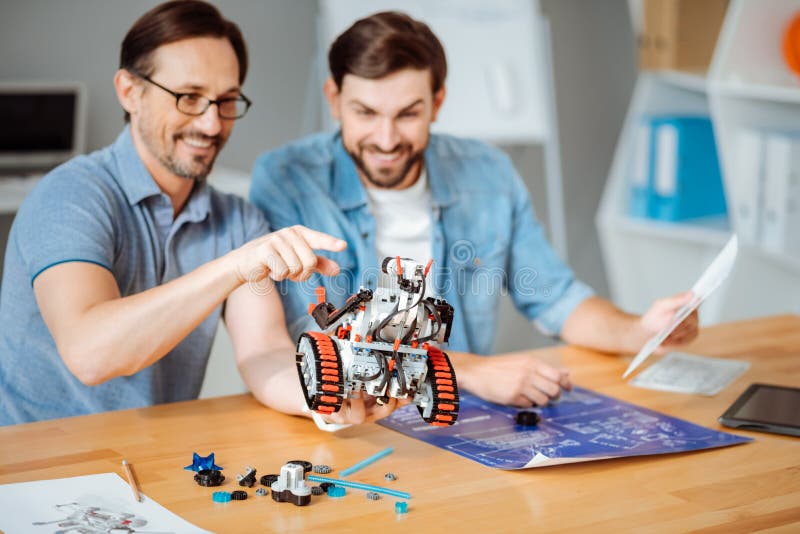 Positive Engineers Examining the Robot Stock Image - Image of engineer ...